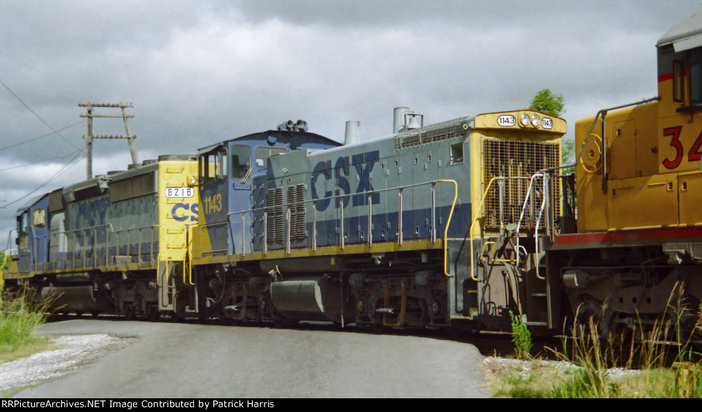 CSX 1143 MP15DC trails CSX 8218 X-L&N 3590 SD40-2 west across Old Gentilly Road and into CSX ...